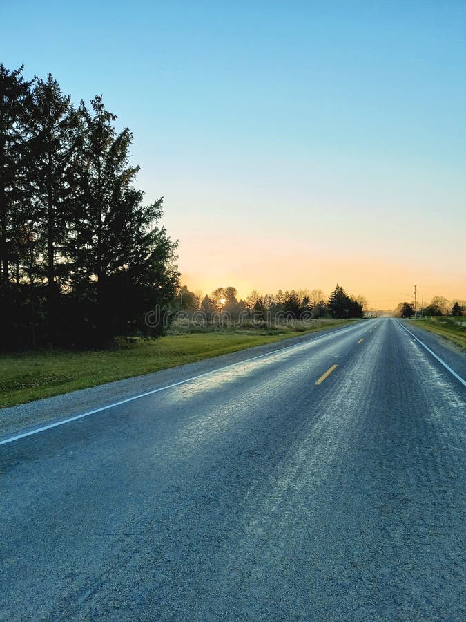 Drive into the Sunset stock photo. Image of grass, road - 261251482