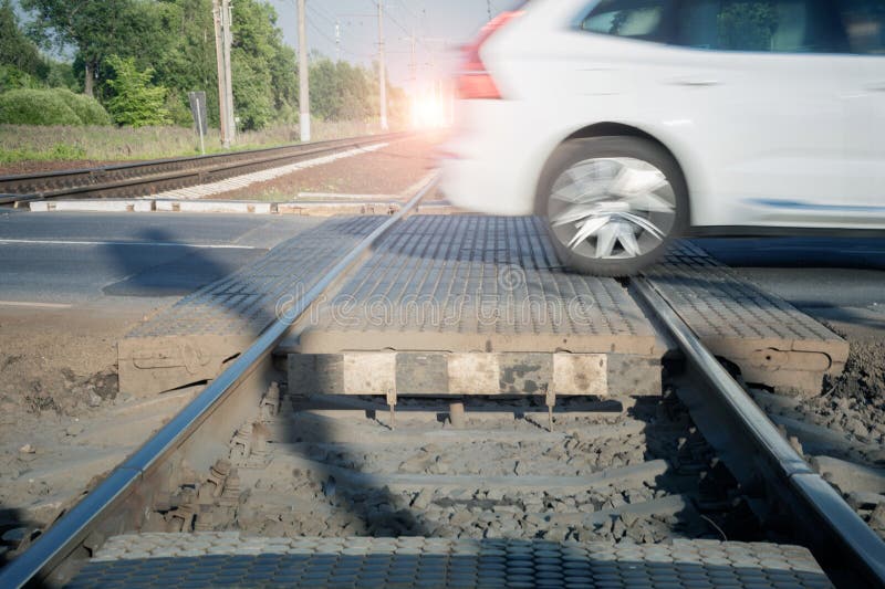 A Driver Crosses a Railroad Crossing in Front of an Approaching Train ...