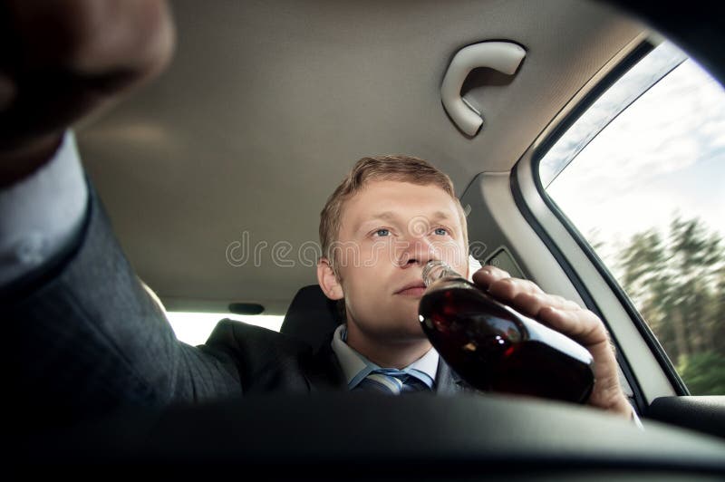 Driver Drinks Alcohol while Driving Stock Photo - Image of automobile ...