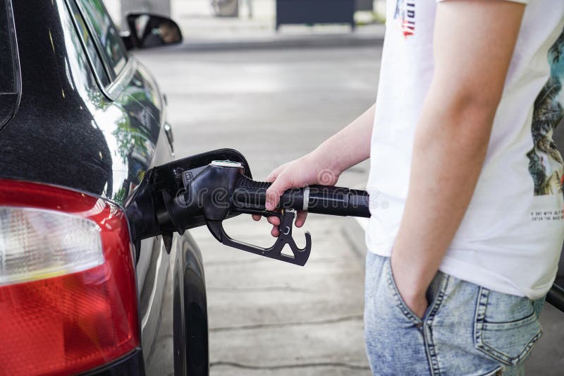 A Driver Fills a Car with Fuel at a Gas Station Stock Photo - Image of ...
