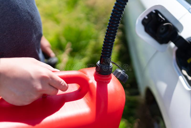 The Driver Fills Up the Empty Tank of the Car from a Red Canister on ...