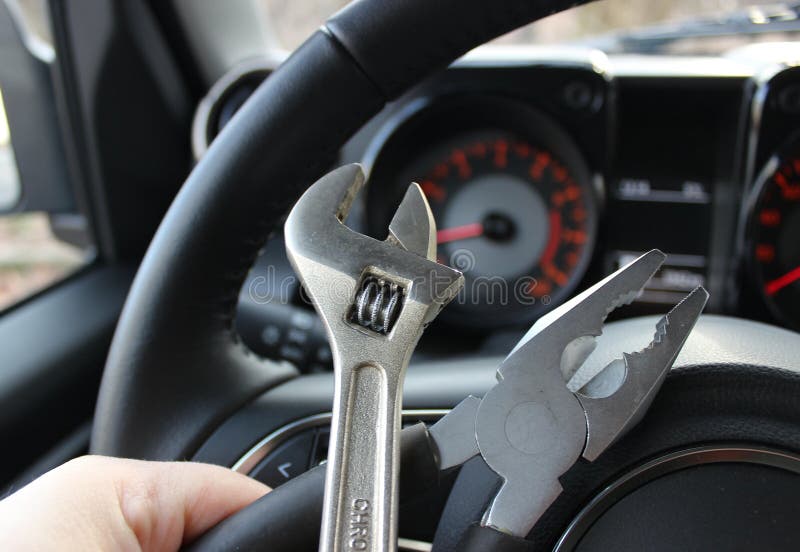 Driver Hand with Engineering Tools in Front of the Steering Wheel and ...