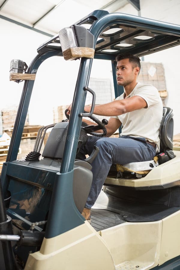 Driver Operating Forklift Machine in Warehouse Stock Photo - Image of ...