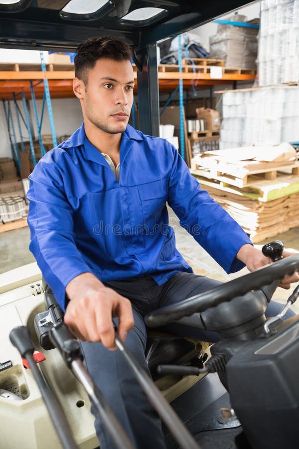 Driver Operating Forklift Machine in Warehouse Stock Photo - Image of ...