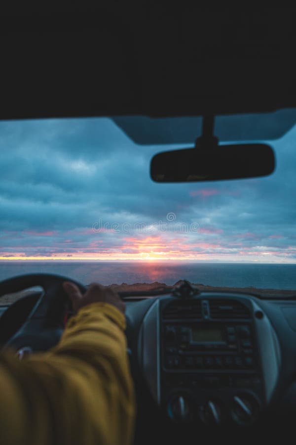 Driver Perspective Captures the View of a Dramatic Sunset Over the ...