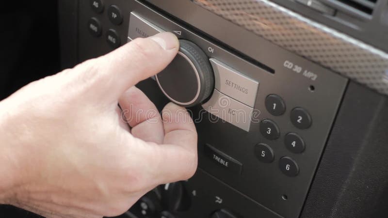 Driver Presses Button on a Car Audio System. Hand Adjusting Car Radio ...