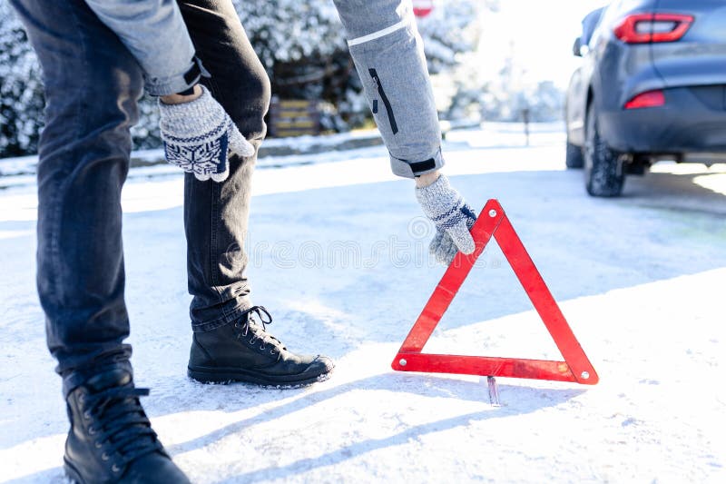 Driver Setting Up Warning Sign Triangle on Cold Winter Day. Broken Car ...