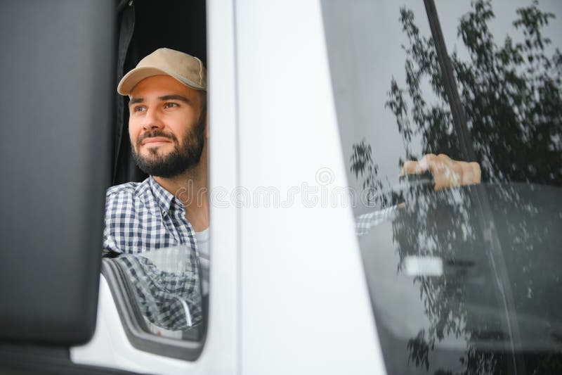 A Driver Sitting Inside the Semi-truck while Looking through the Open ...