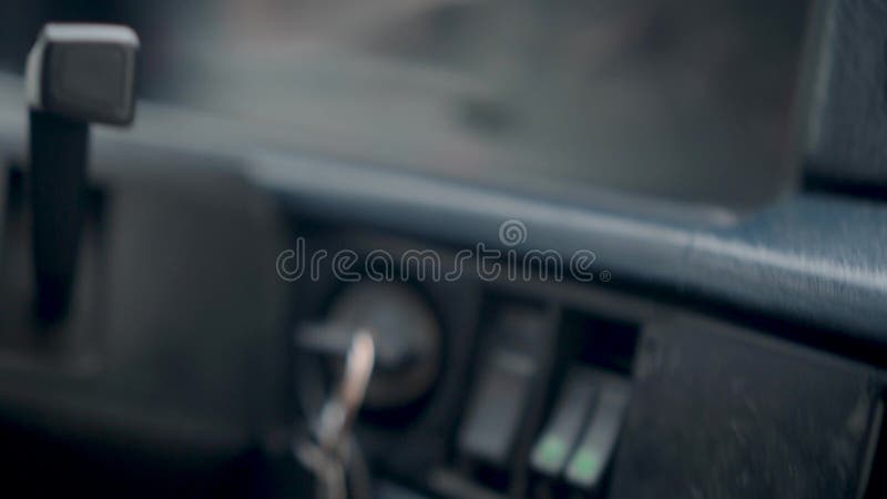 The Driver Starts the Car Engine by Turning the Key. Close-up of the ...