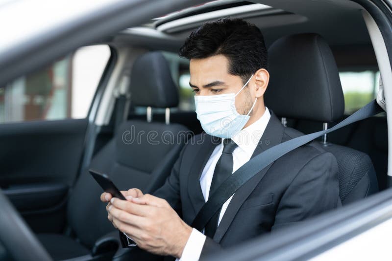 Driver Using Mobile App in Car Stock Image - Image of mask, protection ...