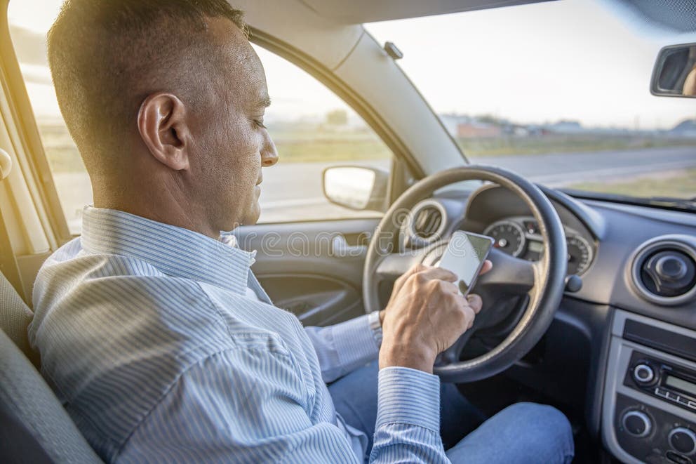 Driver Using a Mobile Phone Inside His Car with Copy Space Stock Photo ...