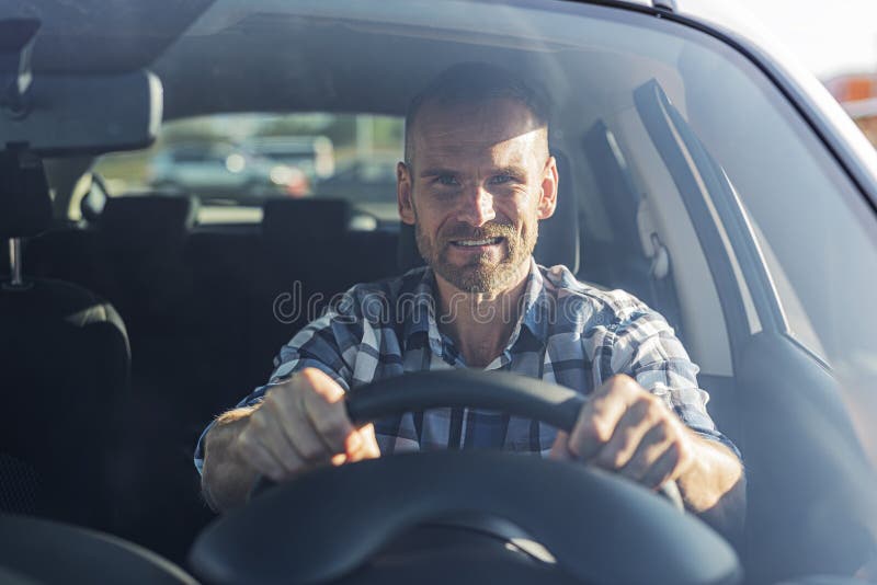 The Driver is a Young Attractive Man Driving a Car. Stock Image - Image ...