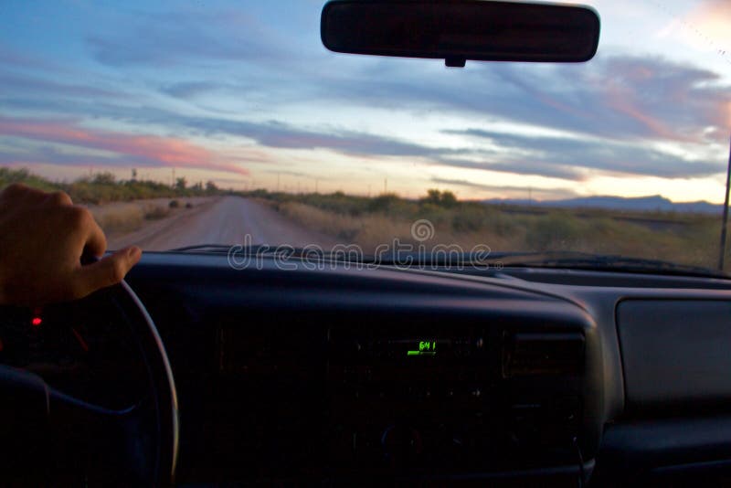 Drivers Point of View of a Drive on a Dirt Road after Sunset, One Hand ...