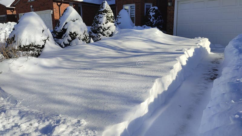The Driveway is Covered with Deep White Snow in Canada for a Weather or ...