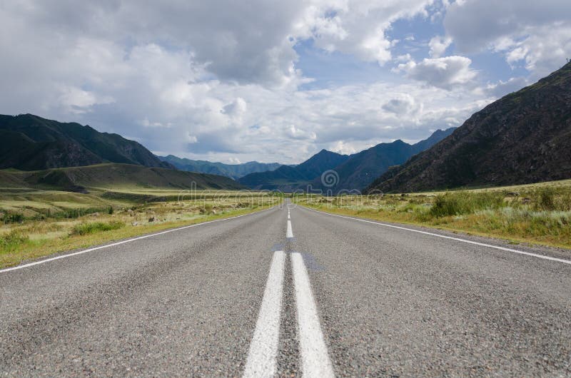 Driving Down an Empty Road with a View of Mountains in the Distance and ...