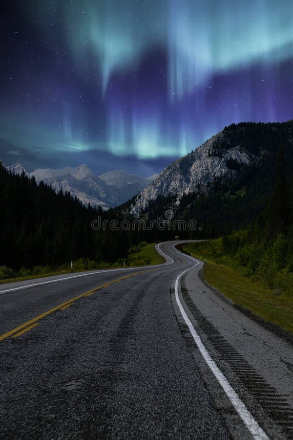 Driving Down the Road at Night with Northern Lights in Sky Stock Image ...