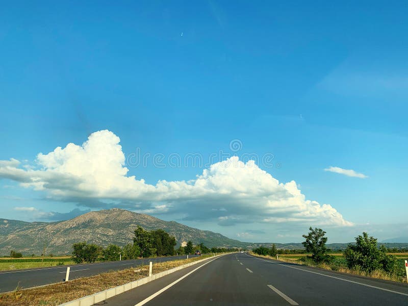 Driving Highway on Blue Sky Background Stock Image - Image of mountains ...