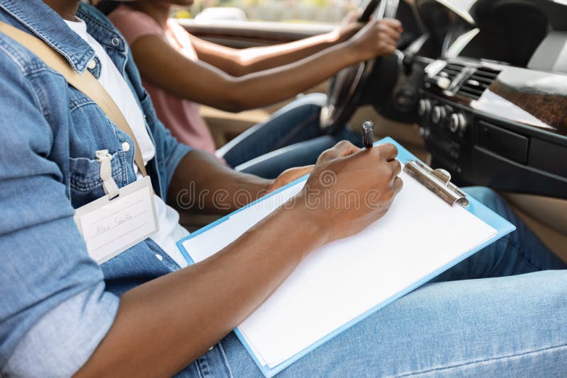 Driving Instructor Taking Notes during Exam, Driving School Concept ...