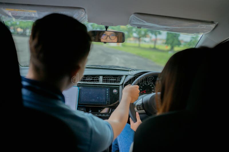 Driving Lesson Providing Instructions and Guidance To a Student Behind ...
