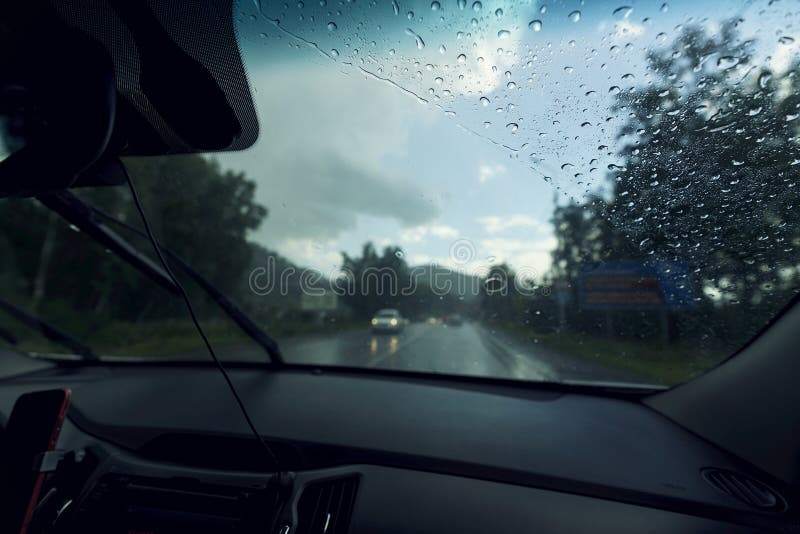 Driving in the Rain, the Windshield Splattered with Raindrops, Working ...