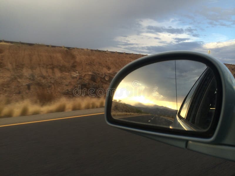 Driving Rear View Side Mirror Looking at the Sunset Stock Image - Image ...