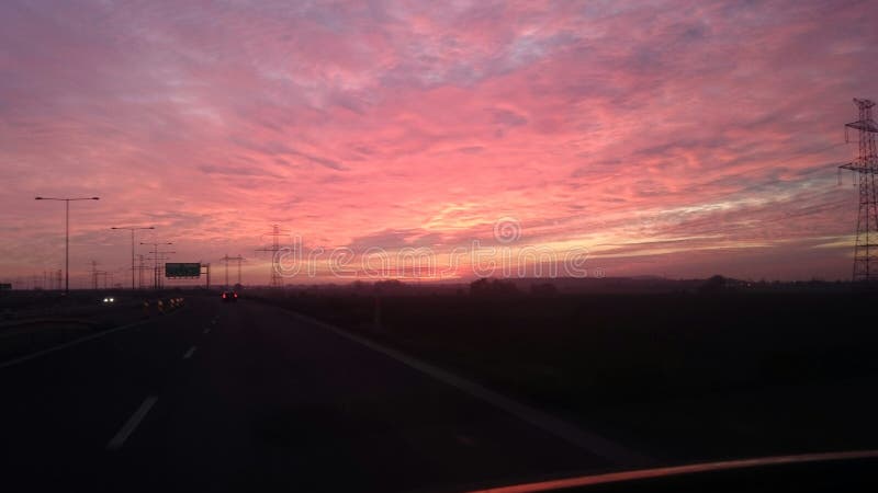 Driving at sunset stock photo. Image of highway, color - 82079676