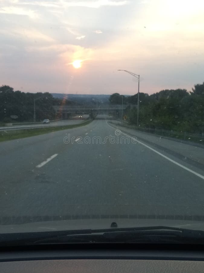 Driving towards the sunset stock photo. Image of road - 154958740