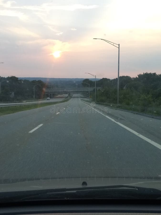 Driving towards the sunset stock photo. Image of driving - 154958744