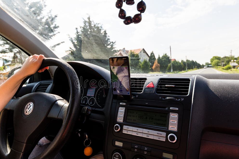 Driving and Using Waze Maps Application on Smartphone on Car Dashboard ...