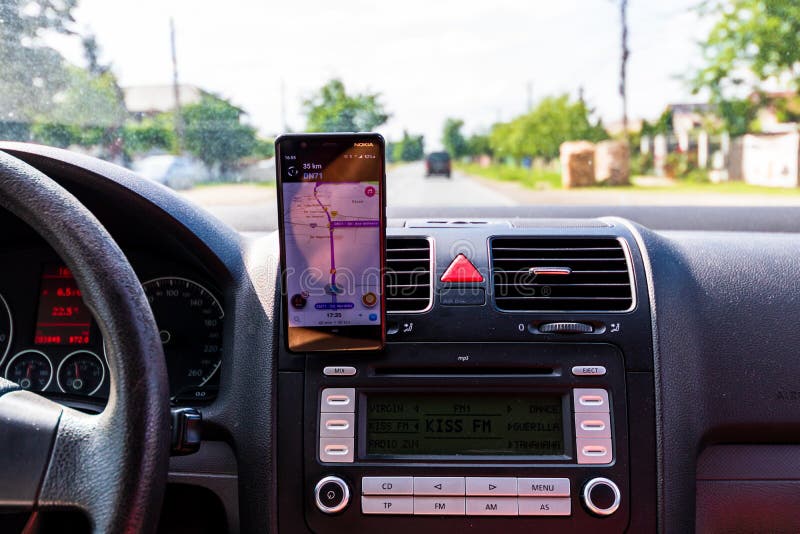 Driving and Using Waze Maps Application on Smartphone on Car Dashboard ...