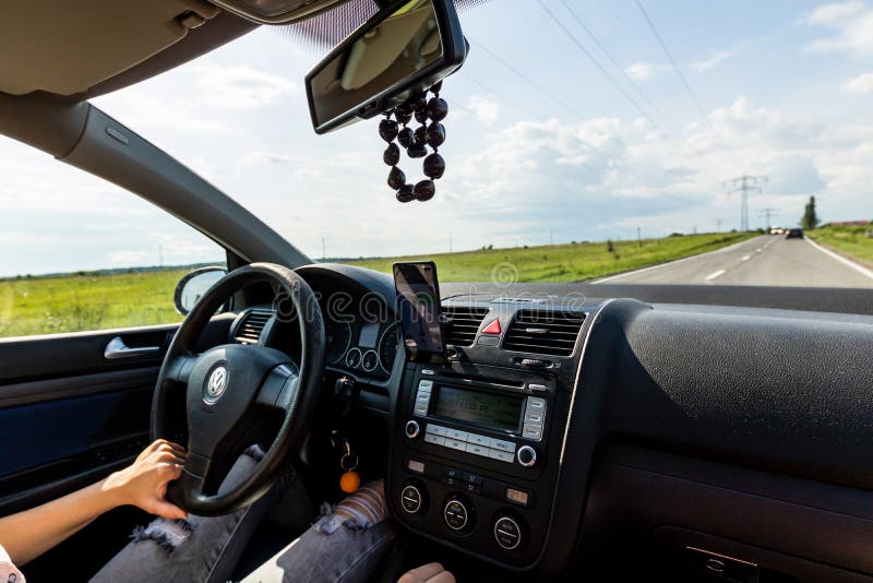 Driving and Using Waze Maps Application on Smartphone on Car Dashboard ...