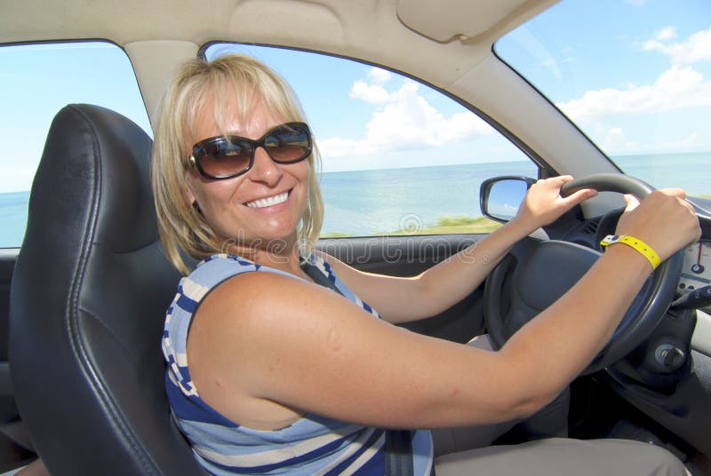 Driving woman stock image. Image of blond, smile, clouds - 15458053