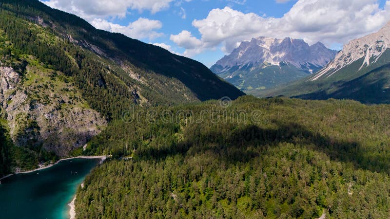 Drone Aerial View of Alpine Lake Surrounded by Forest and Mountains ...