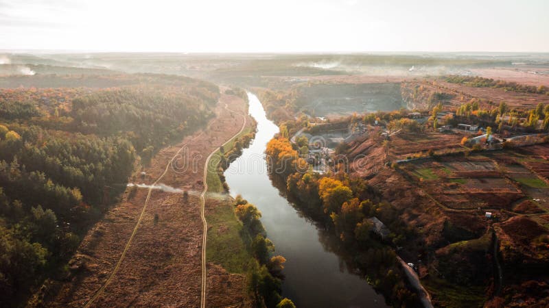 Drone with a Camera, Beautiful River through Career and Forest. C Stock ...