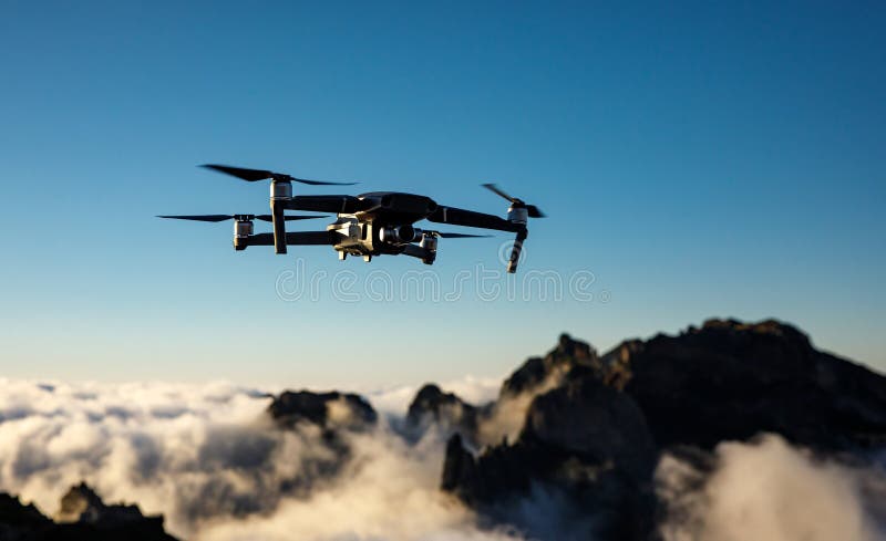 Drone with Camera Flying Over the Mountains Stock Photo - Image of ...
