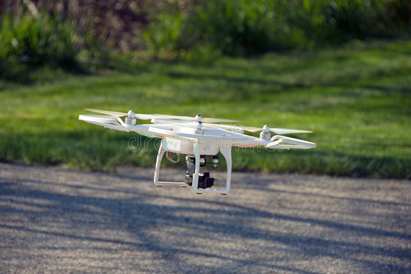 White Drone with Camera in Sky Stock Photo - Image of quad, modern ...