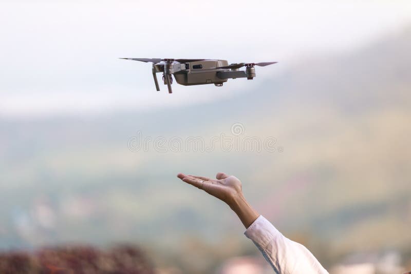 Drone Copter Flying with Digital Camera Near Hand. Stock Image - Image ...