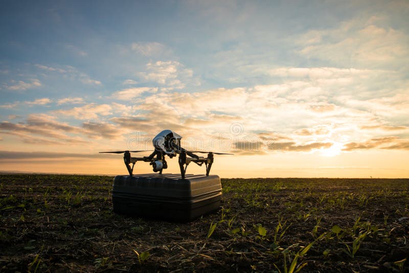 Drone with Digital Camera Flying in Sky Over Field on Sunset Stock ...