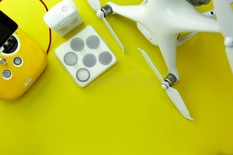 Drone Equipment with Remote Control on Yellow Paper Background, Copy ...