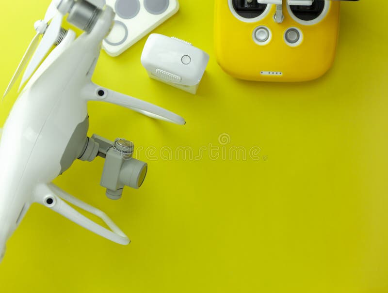 Drone Equipment with Remote Control on Yellow Paper Background, Copy ...