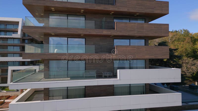 A Drone Flies Along the Facade of a Modern Hotel. Windows and Balconies ...