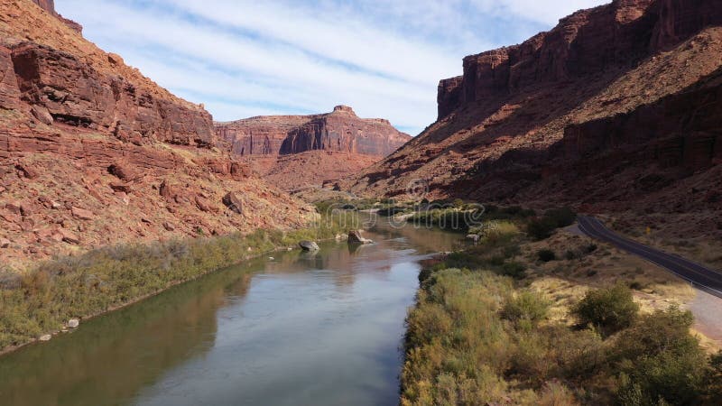 Drone Flies Over Colorado River Surrounded by a Red Massive of Rocks in ...