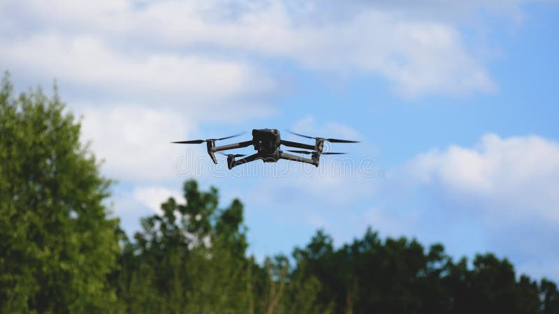 The Drone Flies in the Sky Against the Background of Clouds. Green ...
