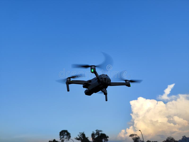 Drone Flying from a Distance Clouds in Background Stock Image - Image ...
