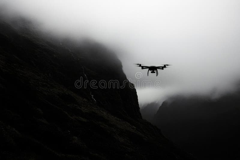 Drone Flying in Misty Mountain Landscape with Fog and Steep Cliffs ...