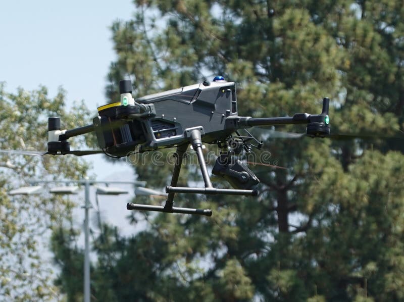 Drone Flying Over an Park with Parachute Equipped Stock Image - Image ...