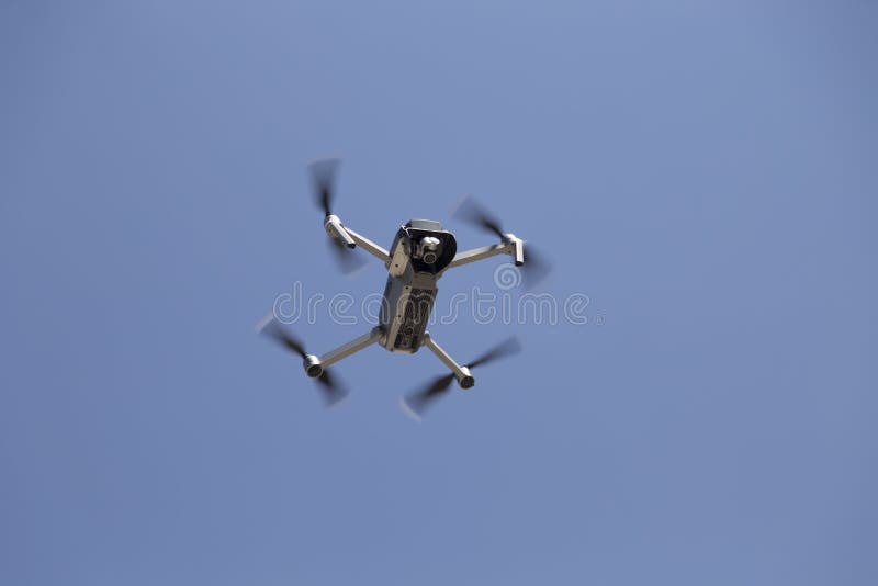 Drone Flying Overhead in Cloudy Blue Sky Stock Image - Image of copter ...