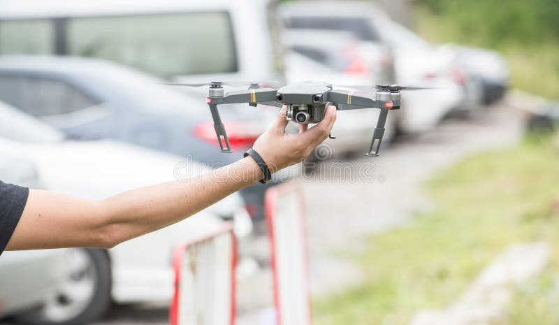 Cropped Shot View of Human Holding a Flying Drone in His Hand. Stock ...