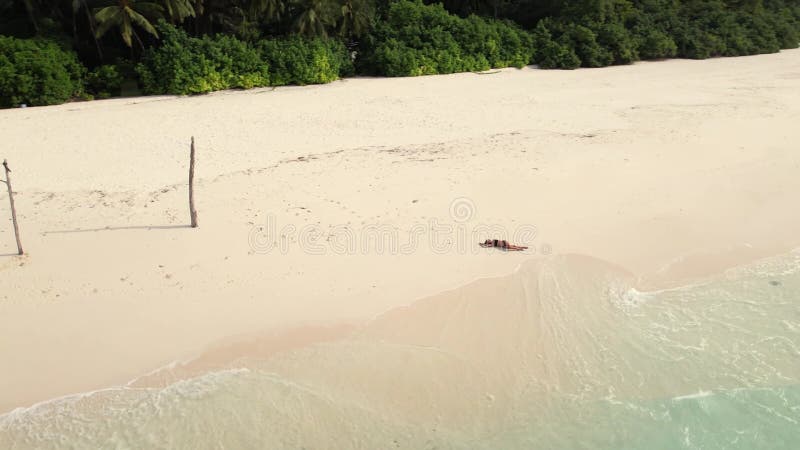 Aerial Flyover Drone Shot Of Woman Lying On Sandy Beach And Ocean Waves
