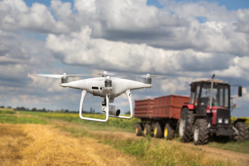 Drone in Front of Tractor in Field Stock Photo - Image of farmland ...